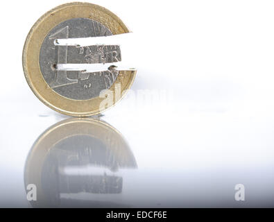 ILLUSTRATION - This illustration shows a damaged euro coin in a vise in ...