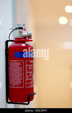 Fire extinguisher hanging on the wall of the hotel corridor, the symbol ...