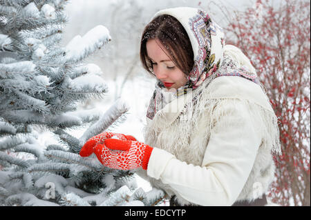 A beautiful young Russian woman in a park in the first warm spring sun ...