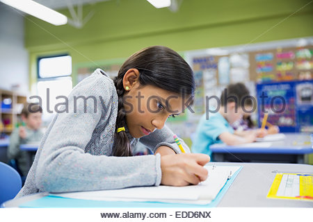 Indian School Girl Student Writing Note Book Studying In Classroom ...