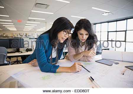 Architects drafting blueprints in office Stock Photo - Alamy