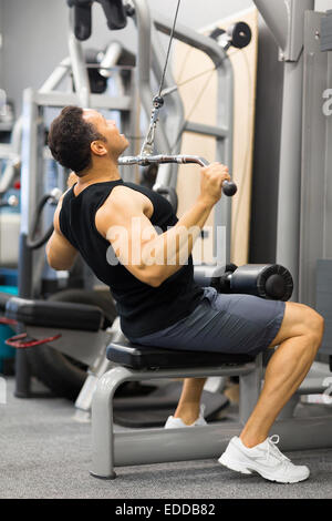 Bodybuilder in gym working out on legs machine Stock Photo - Alamy