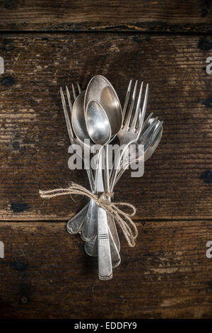 Old forks and spoons tied up with string Stock Photo - Alamy