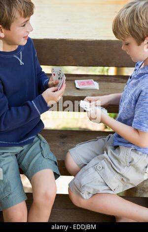 Two brothers playing cards Stock Photo - Alamy