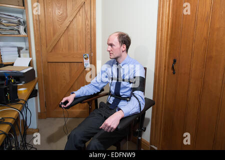 Man being examined using a Polygraph test lie detector machine which ...