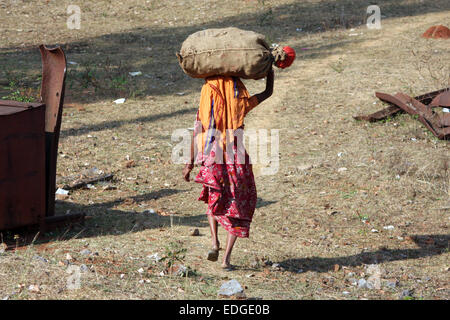Woman carrying large heavy load at the Otavalo market Ecuador South ...