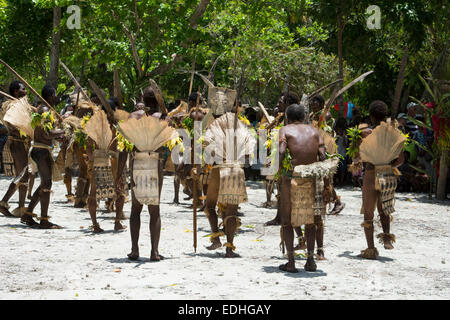 A group of Melanesian people in traditional white head dress holding ...