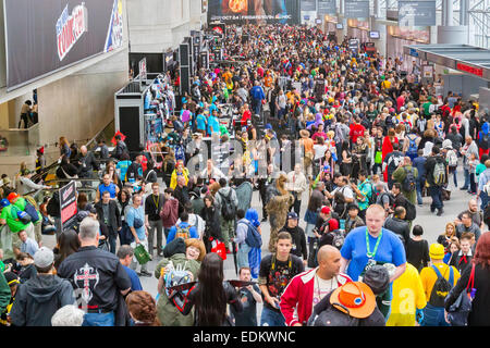 A crowd of visitors and fans to the New York ComicCon comic book and ...