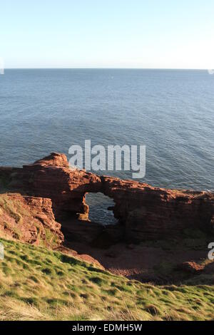 Needle E'e rock arch in red sandstone Seaton Cliffs Angus Scotland ...