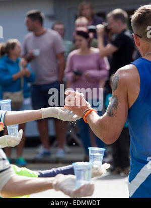Water station at a 10k running road race Stock Photo - Alamy