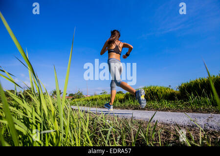 Running in rice field in Bali, Indonesia Stock Photo - Alamy