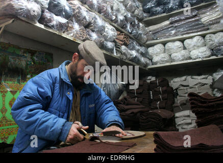 Peshawar. 9th Jan, 2015. A man sells traditional caps inside a shop at ...