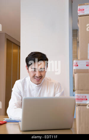 Online seller using laptop Stock Photo - Alamy