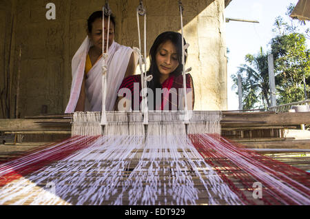Sivasagar, Assam, India. 9th Jan, 2015. A girl weaves gamosa ...