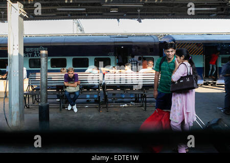 Passengers couple having conversation as they are standing on passenger ...