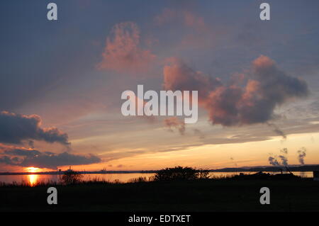 Smokes and clouds in sunset, Animal Island (Djurön), Sweden Stock Photo ...