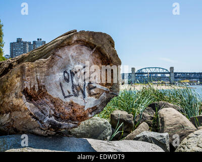 Graffiti on a log Stock Photo - Alamy