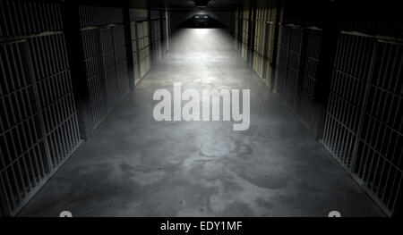 A corridor in a prison at night showing jail cells illuminted by ...