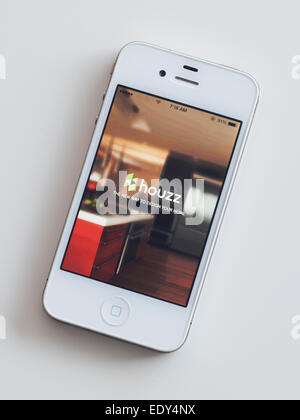 The homescreen and logo of the Houzz mobile app on a white Apple iPhone ...