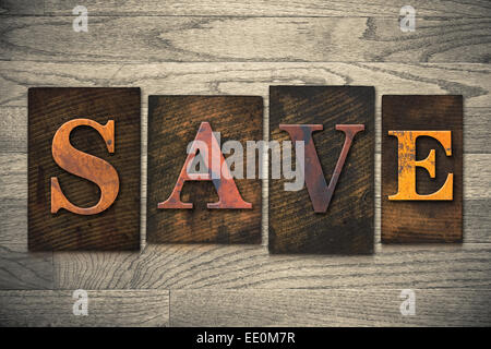 The word "save" written in wooden letterpress type on a white washed ...