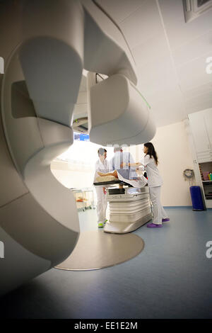 Prostate cancer radiotherapy surgery. Patient under general anaesthetic ...