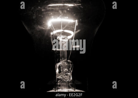 ordinary lighted lamp on a dark background Stock Photo - Alamy