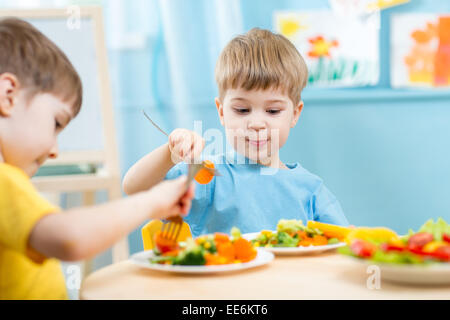 Preschool children eating breakfast in the school classroom Stock Photo ...