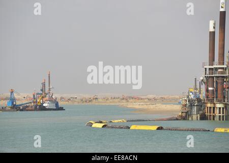 Earthmoving and dredging machines in action digging the new Suez Canal ...