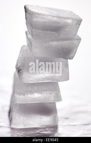 Pile of melting ice cubes and water drops on light grey background ...