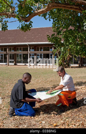 Geologist training apprentice from local community to work on nearby ...