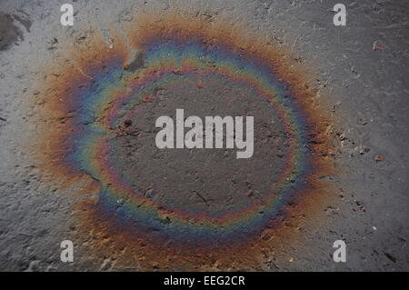 Puddle of oil on pavement Stock Photo - Alamy