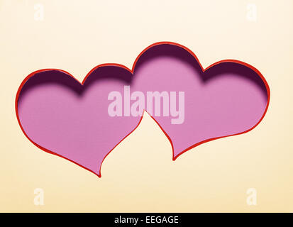 Two hearts cutout in paper with words "Happy Valentine's Day" inside ...