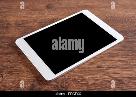White digital tablet on wooden table Stock Photo - Alamy