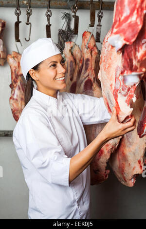 Butcher checking quality of meat at slaughterhouse Stock Photo - Alamy