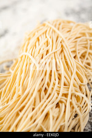 Raw spaghetti background. Unprepared spaghetti on a dark wooden table ...