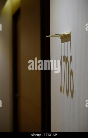 A room number cast a shadow on a wall in the luxurious Sofitel So hotel ...