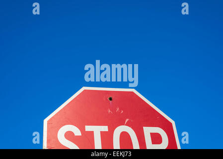 Conceptual image showing a half of a stop sign. Don't stop halfway ...
