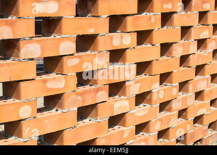 Overlapped bricks held together with mortar forming a curved brick wall ...