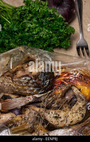 fragrant slices in greens with oven roasted fresh fish Stock Photo - Alamy