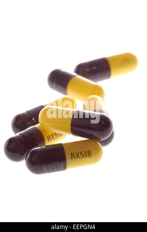 Close up of prescription medicine. Pill packaging isolated on black background. Two color pill ...