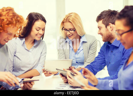 smiling team with table pc and papers working Stock Photo - Alamy