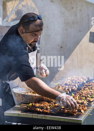 grilling meat and vegetables on a skewer on an outdoors grill Stock ...