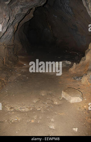 Natural dark and scary underground cave with strangely shaped stone ...