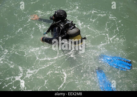 Commercial deep sea diver entering the water with a splash Stock Photo ...