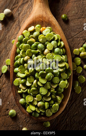 Raw dried green peas in a bowl over stone background with copy space ...