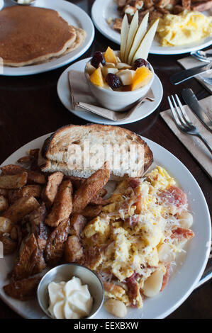 Hearty breakfast of eggs, fruit, and toast sits in natural light Stock ...
