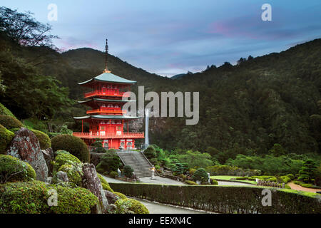 A traditional red Shinto temple complex in Kyoto Japan with red torii ...
