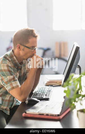 Middle age man using computer laptop at home doing ok gesture with hand ...