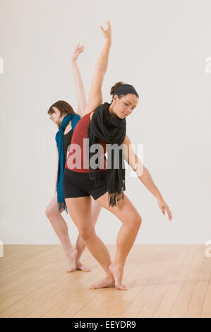 Ballet dancers with long blue hair and fans dance across the stage ...