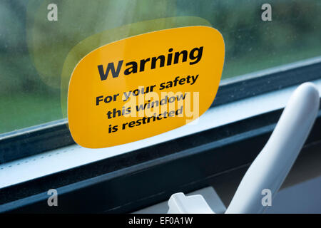 Warning sticker on restricted window Stock Photo - Alamy